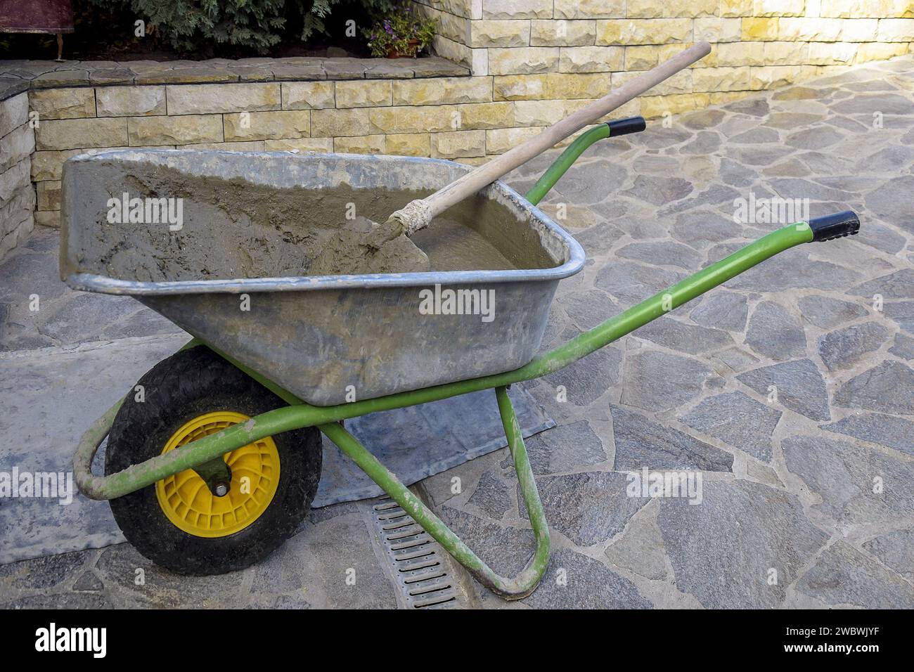 Building trolley with concrete prepared for work. Shovel is stuck in ...