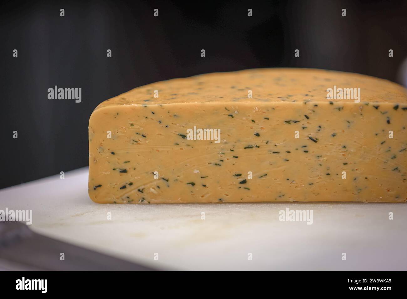 A colorful yellow wedge of Double Gloucster Cheese inside of a craft ...