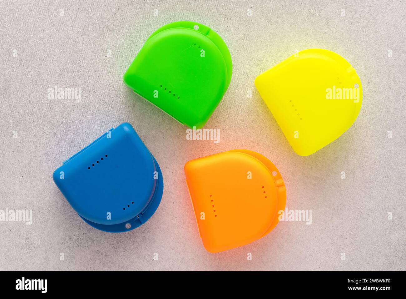 Multi-colored containers for dental plates. Box for orthodontic ...