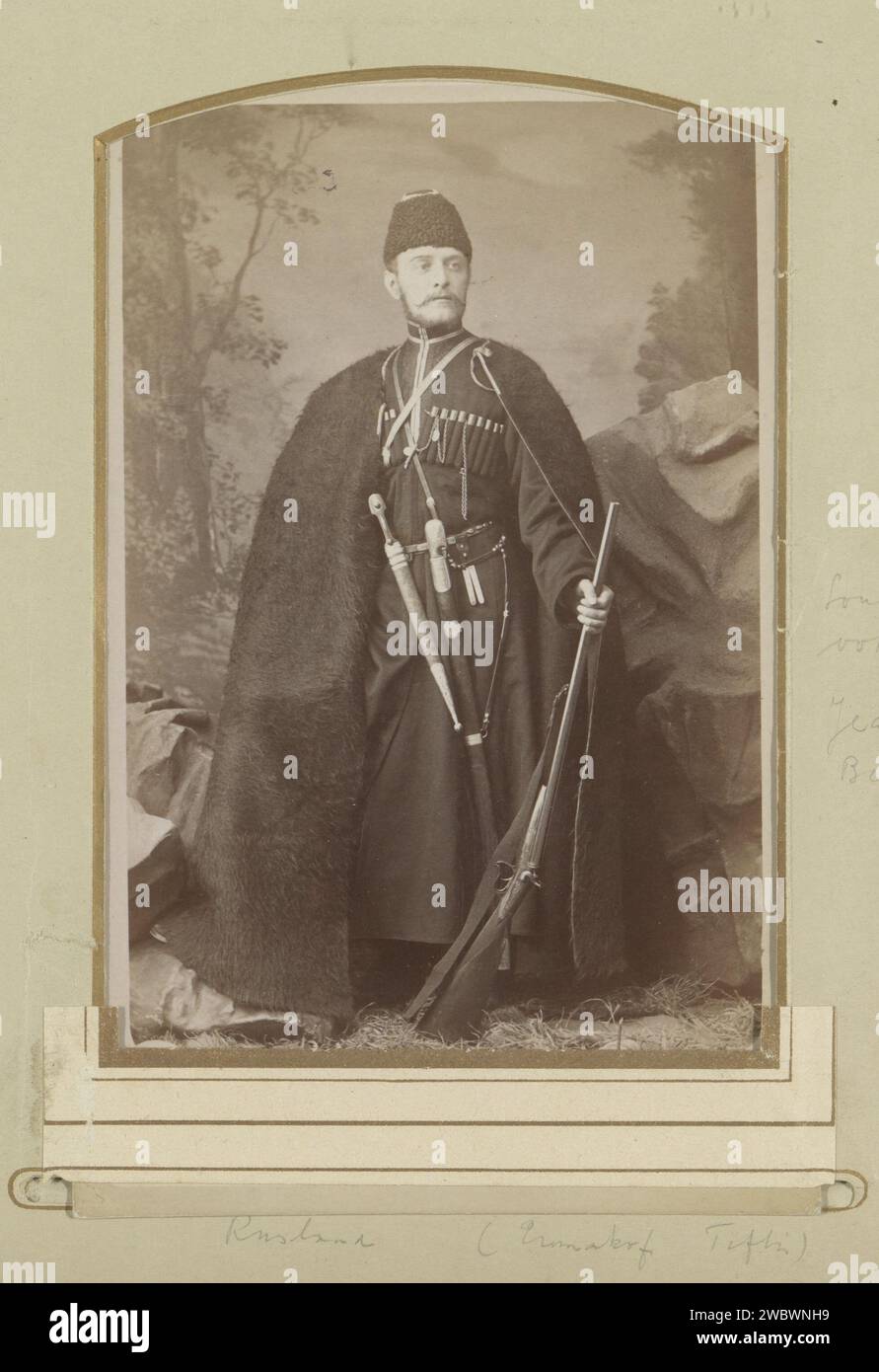 Portrait of a (presumably) Russian soldier, standing with a fur coat ...