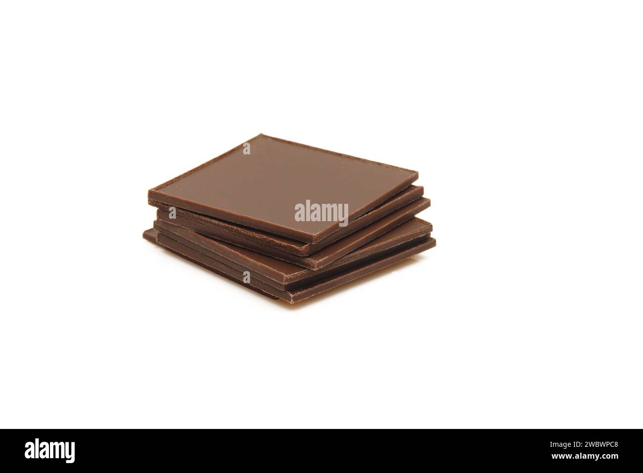 Stack of thin square pieces of chocolate isolated on white background ...