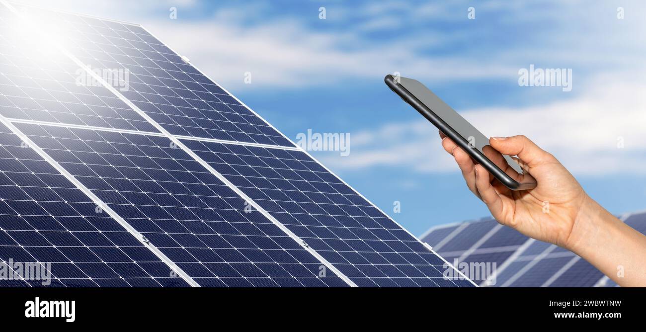 Remote control of solar panel with mobile phone. Smart phone in hands ...
