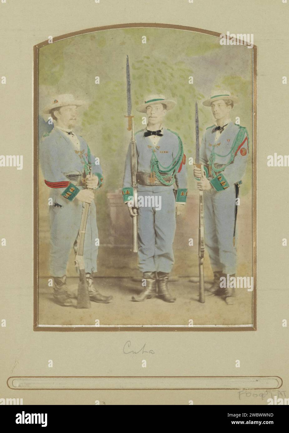 Group portrait of three (presumably) Cuban soldiers, standing with guns ...