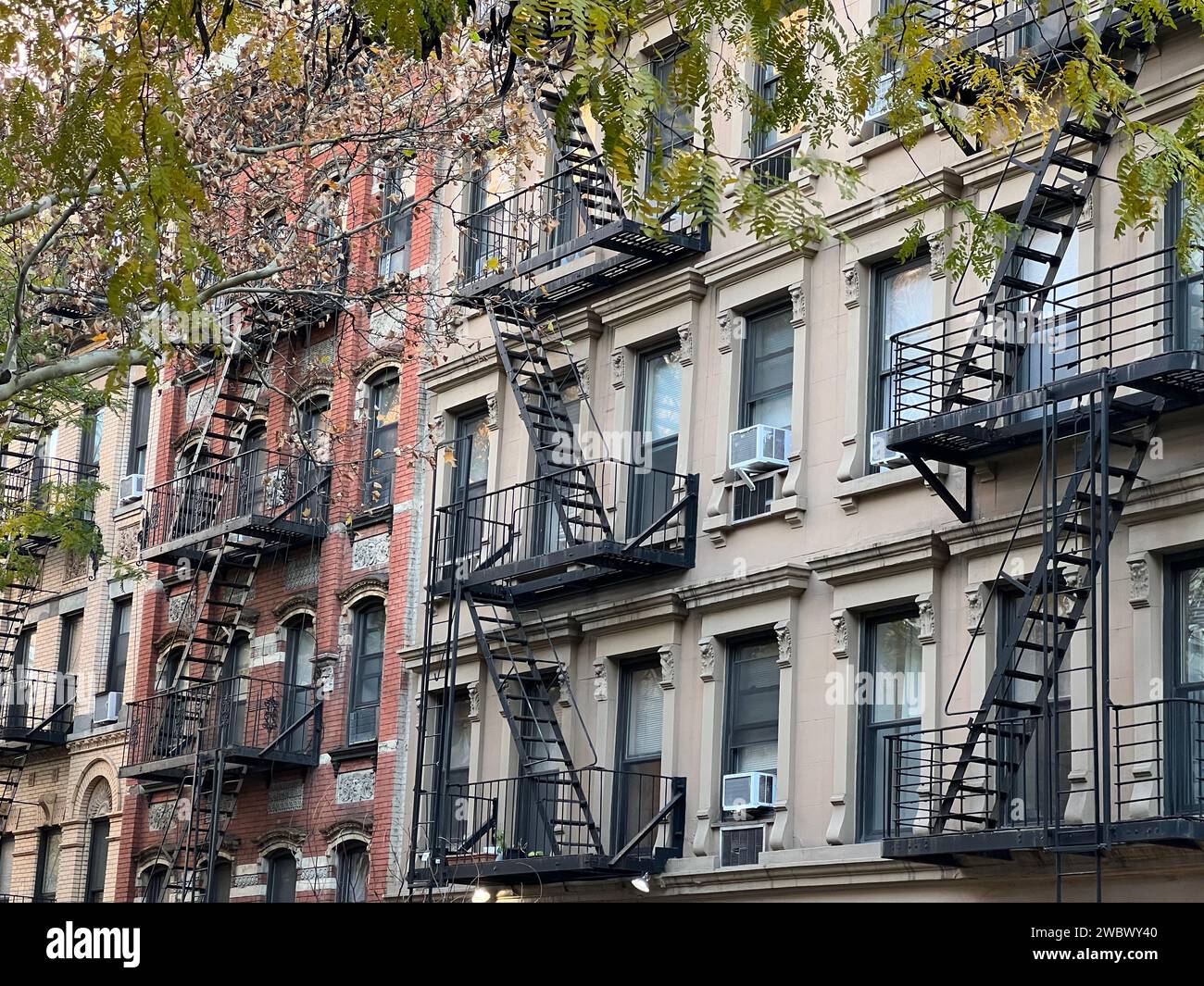 Old colorful buildings with fire ladder and trees on New-york manhattan ...