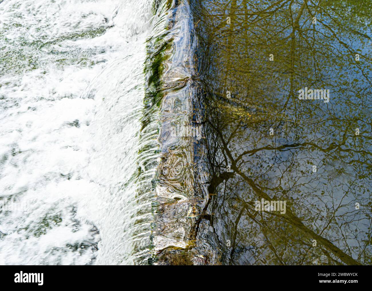 Cascading water over weir showing white foaming water Stock Photo - Alamy