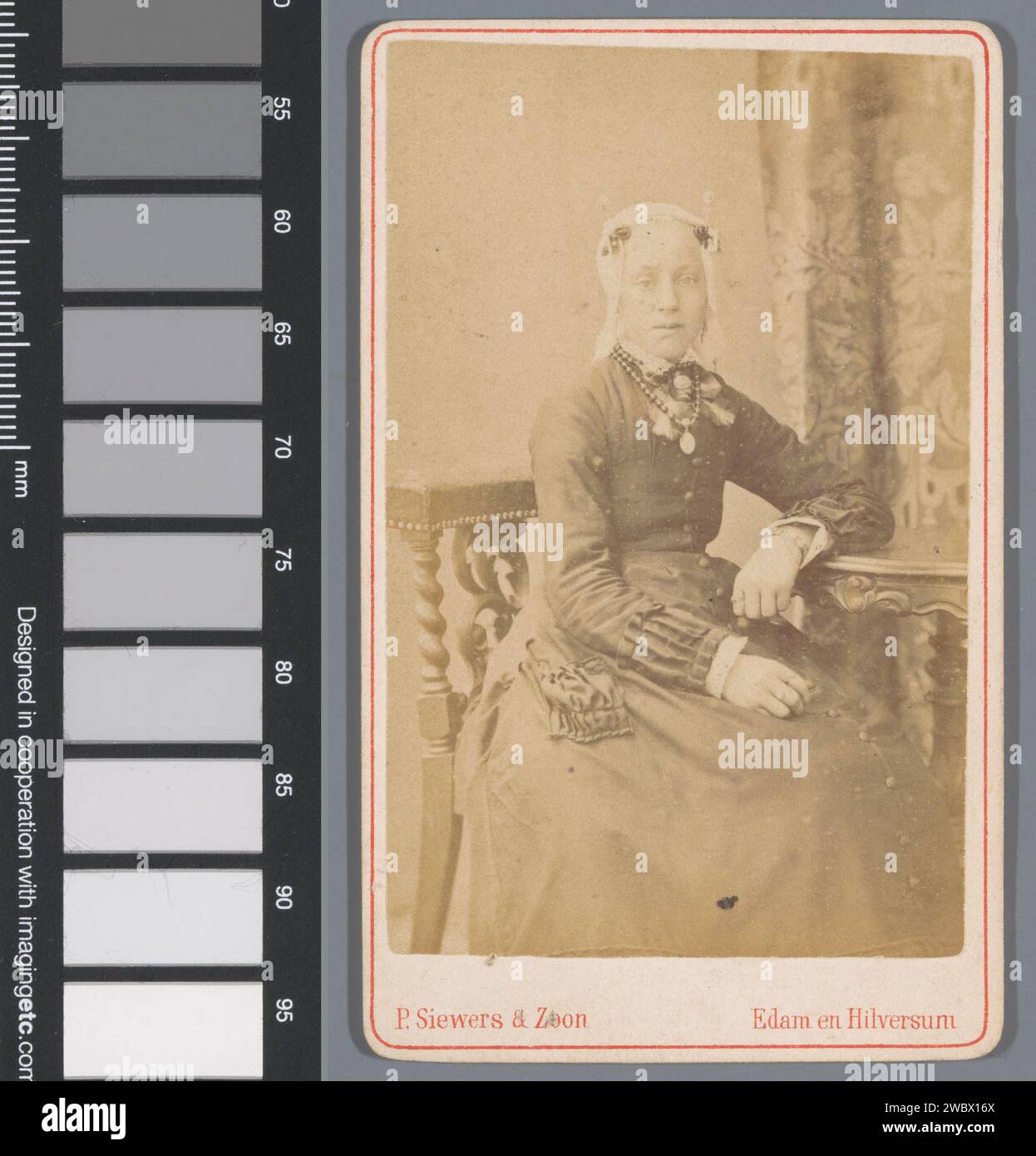 Portrait of an unknown woman with a hat, sitting at the table, P ...
