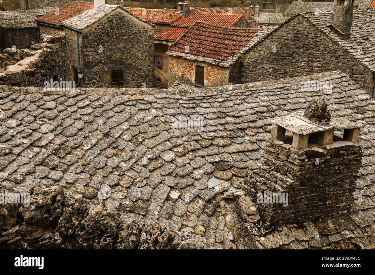 Stone roofs and chimneys in La Couvertoirade, a fortified medieval city ...