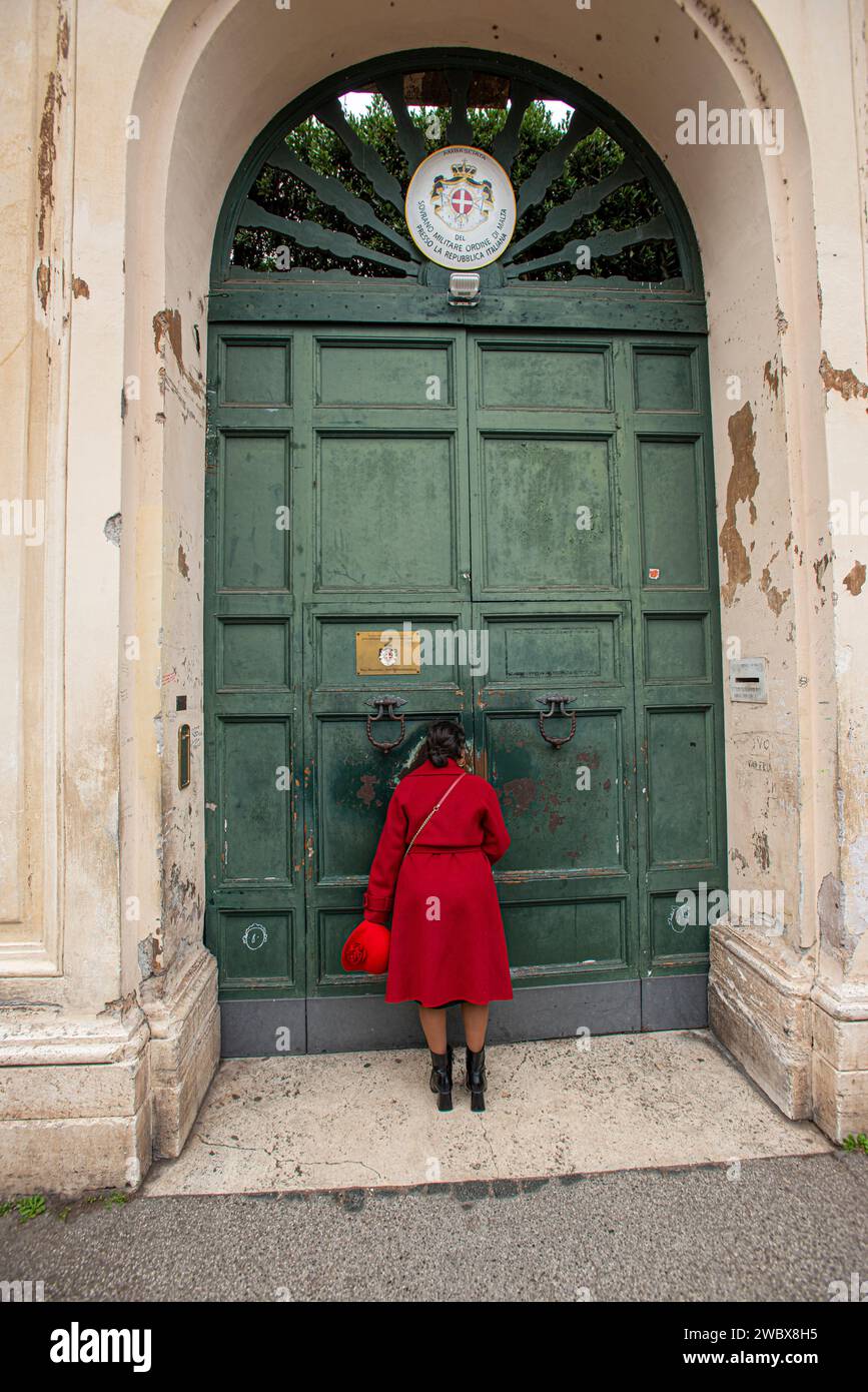 Latin American woman looking through keyhole, Rome, Italy Stock Photo ...