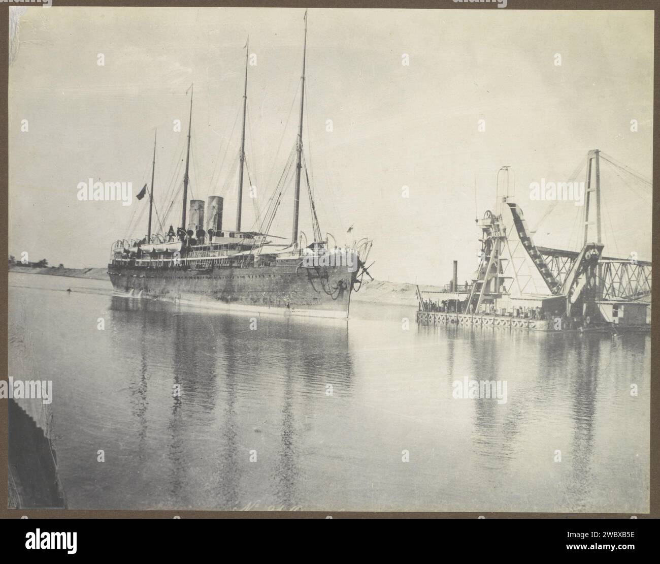 Ship sails through the Suez Canal near a dredger, C. & G. Zangaki ...