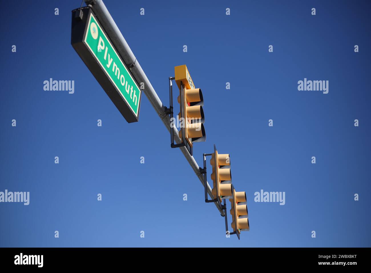 A high-angle shot capturing two vibrant green street signs and a ...