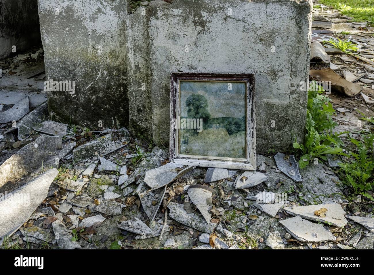 Exterior of a ruined building with pieces of broken roof tiles and ...