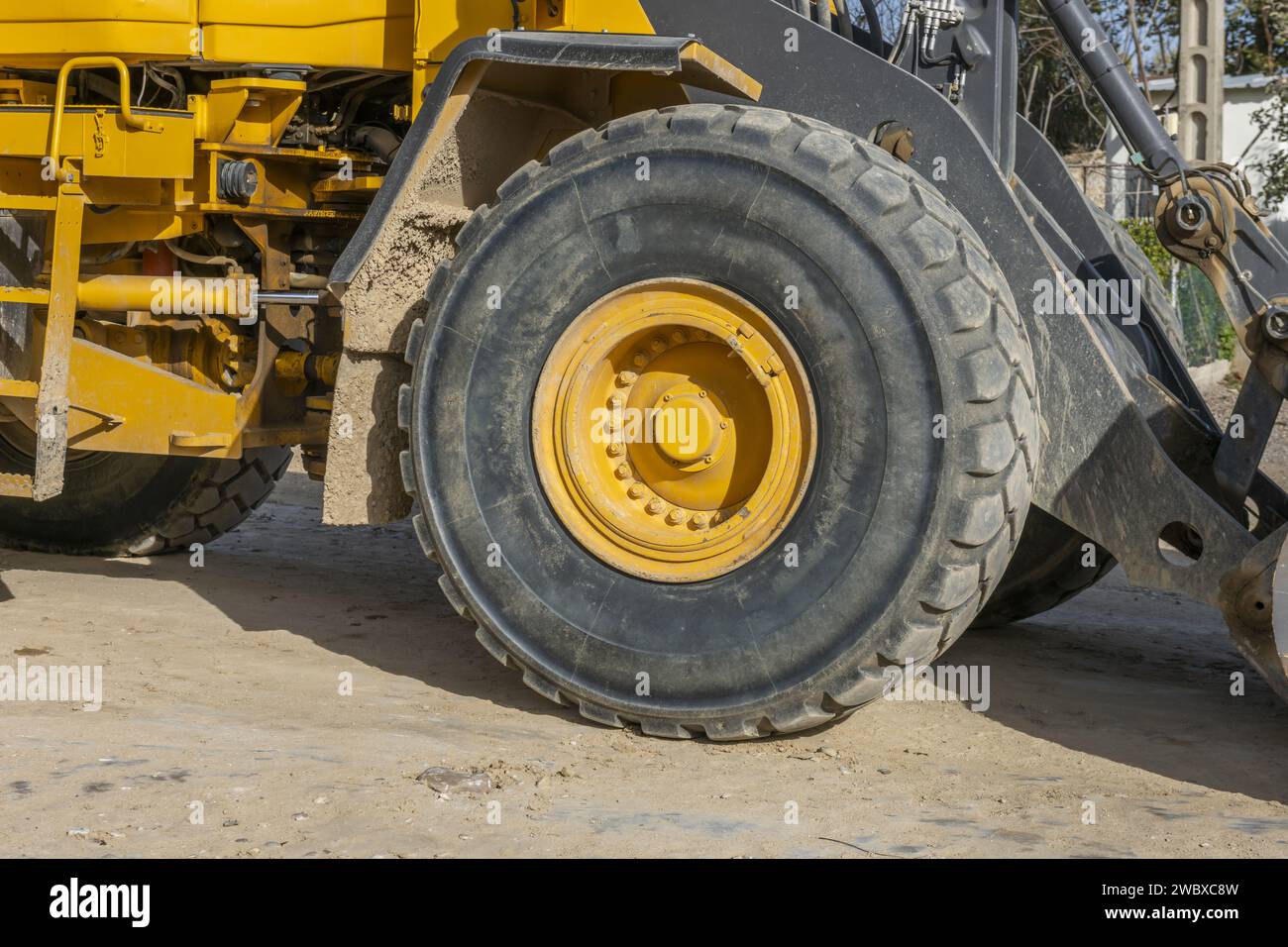 A large rubber tire on the wheel of a civil works bulldozer Stock Photo ...