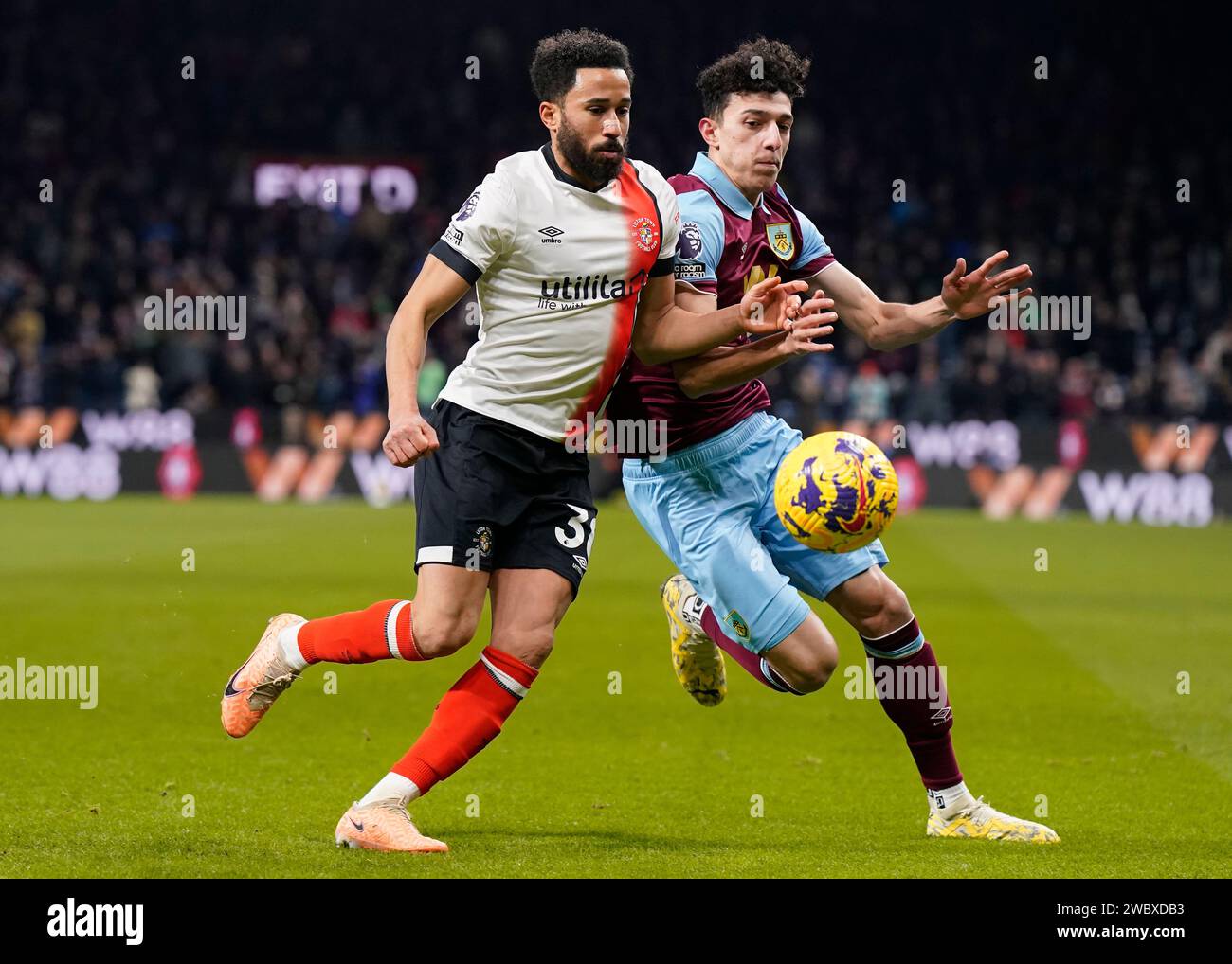 Burnley, UK. 12th Jan, 2024. Andros Townsend of Luton Town tussles with ...