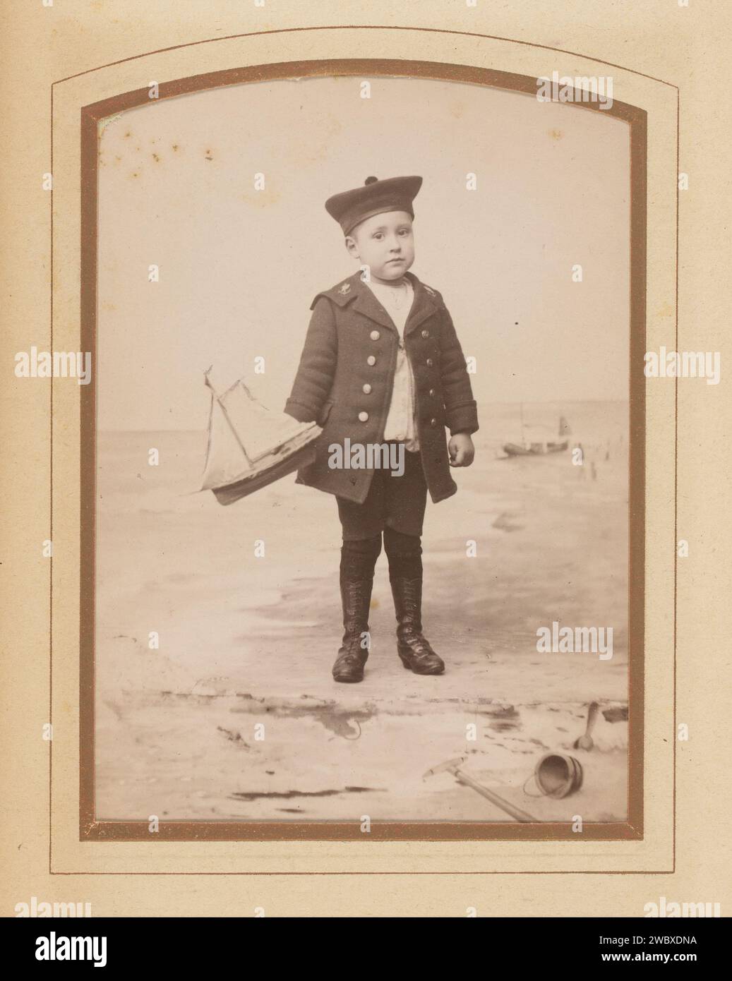 Portrait of a boy with toy boat, Hendrik Jonker, 1882 - 1914 photograph ...