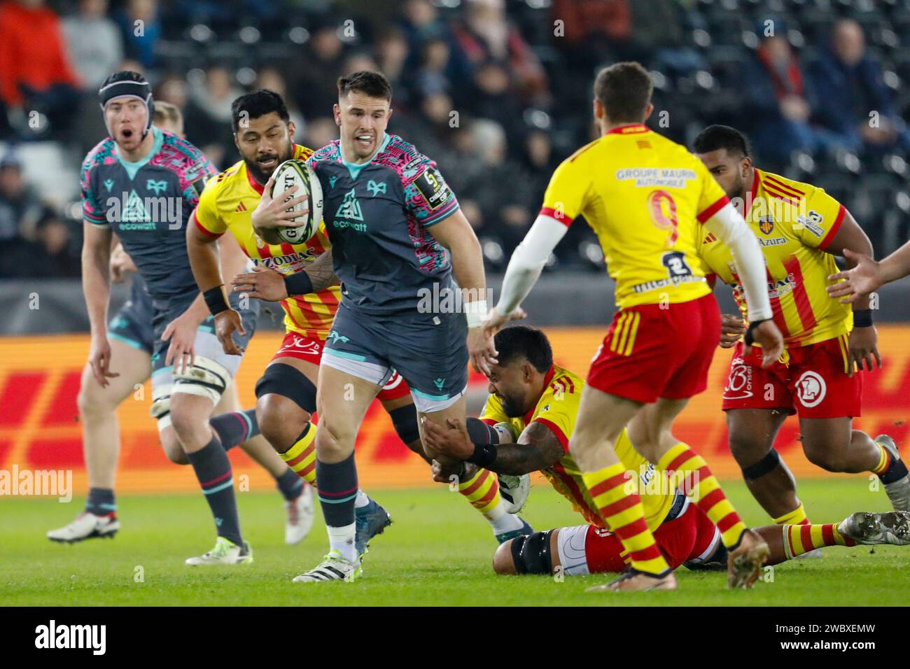 Swansea, UK. 12th Jan, 2024. Owen Watkin of Ospreys (c) makes a break ...