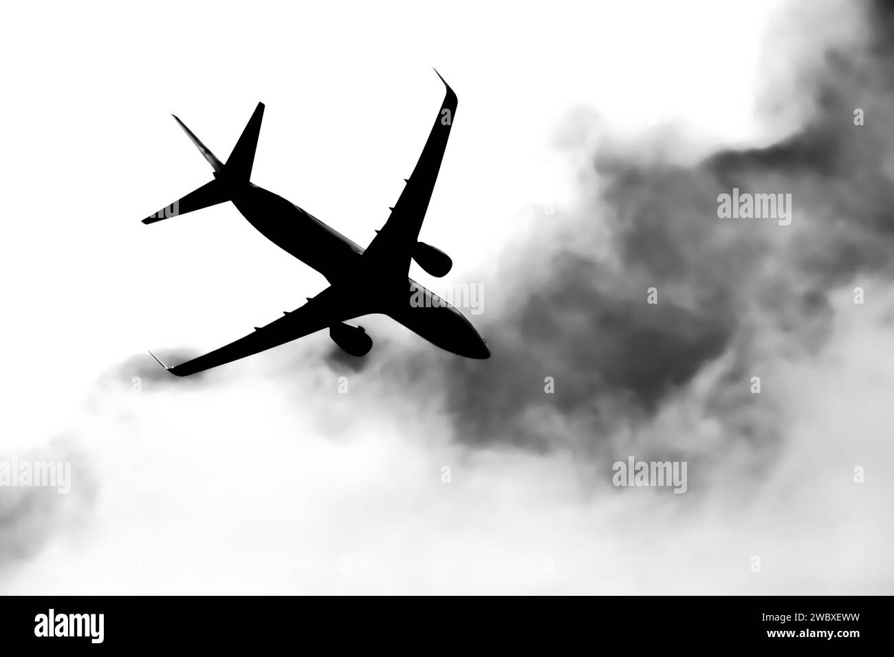 Passenger plane passing through the clouds Stock Photo - Alamy