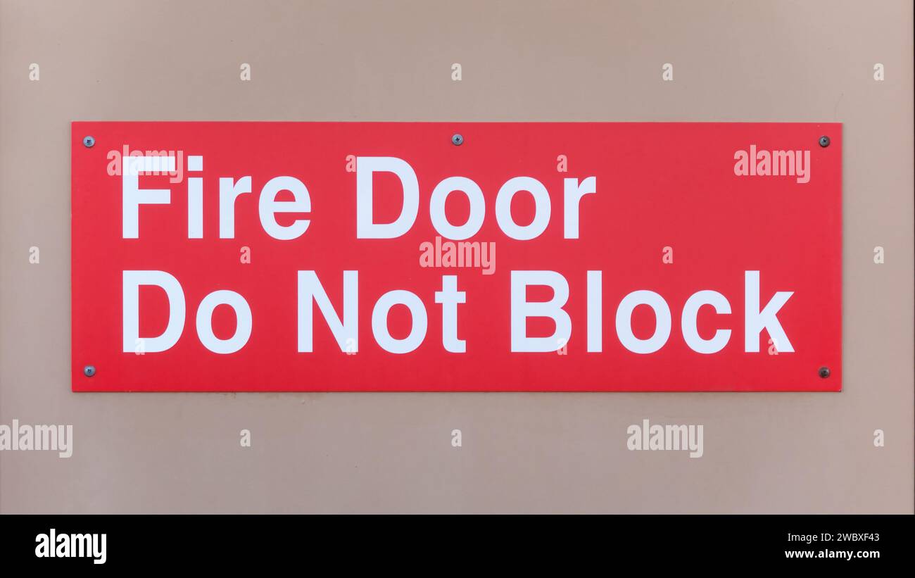 Fire door signage on fire safety exit door Stock Photo - Alamy