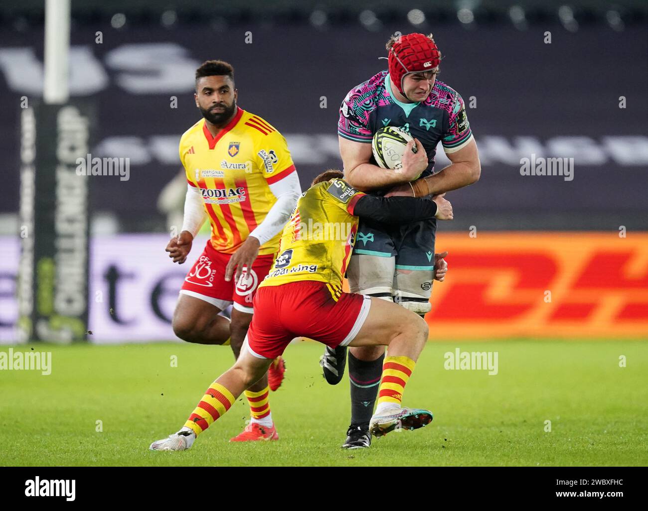 Ospreys' James Fender (right) is tackled by USA Perpignan's Lucas ...