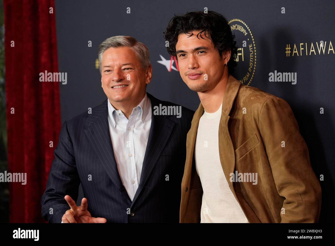 Ted Sarandos, left, and Charles Melton arrive at the AFI Awards on ...