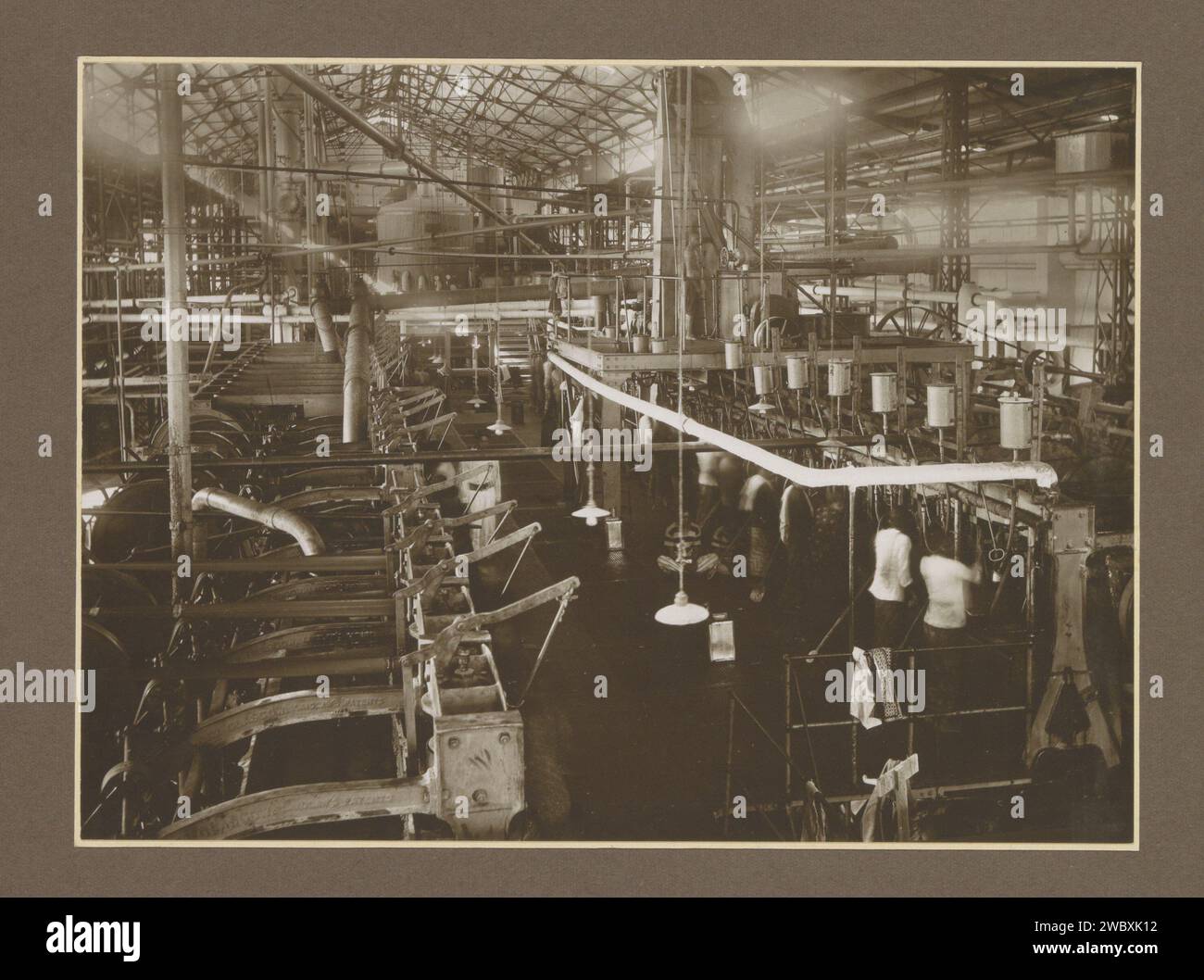 Employees in the centrifuge house of sugar factory Ngandjoek on Java, c ...
