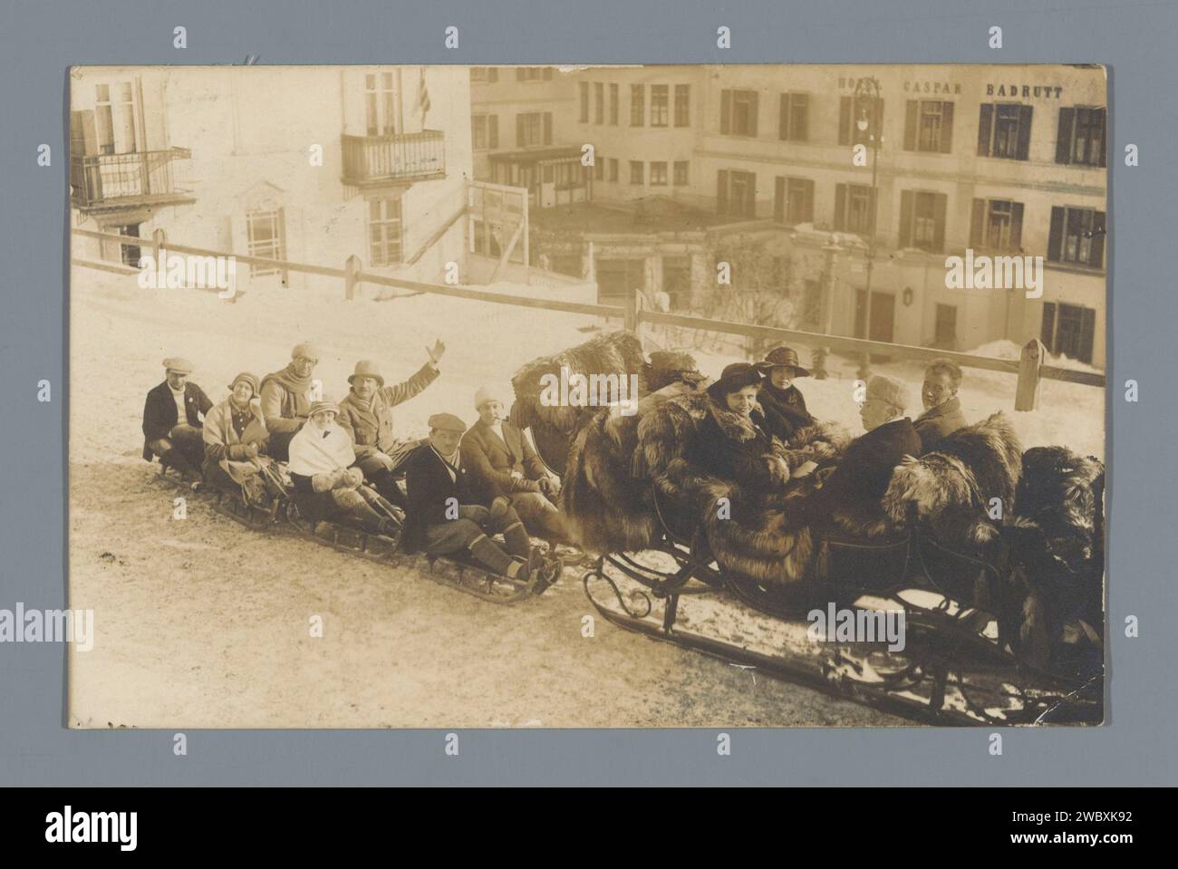 Seven unknown people on wooden sledges behind a horse -drawn sled ...