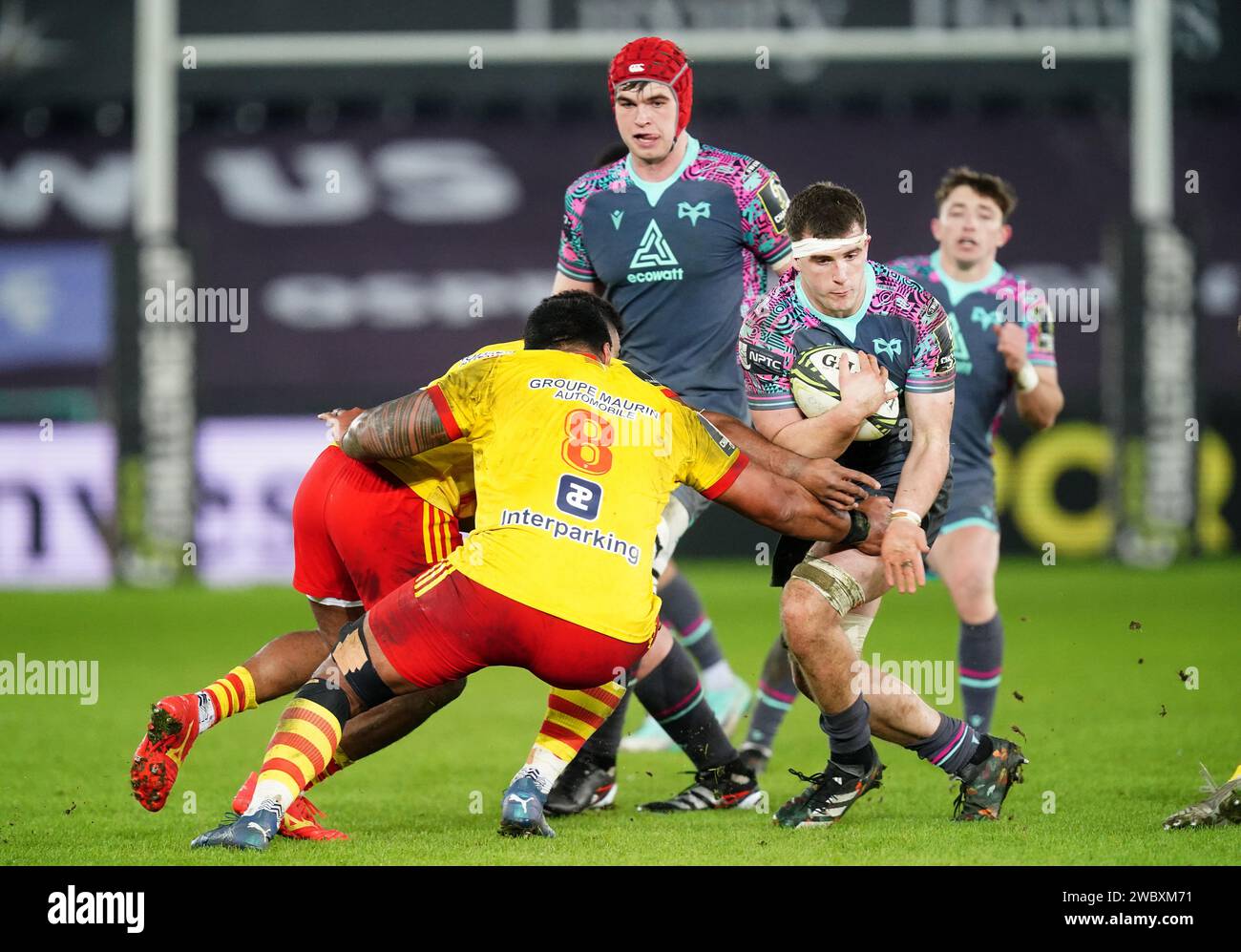 Ospreys' Morgan Morse (centre) is tackled by USA Perpignan's Sootala ...
