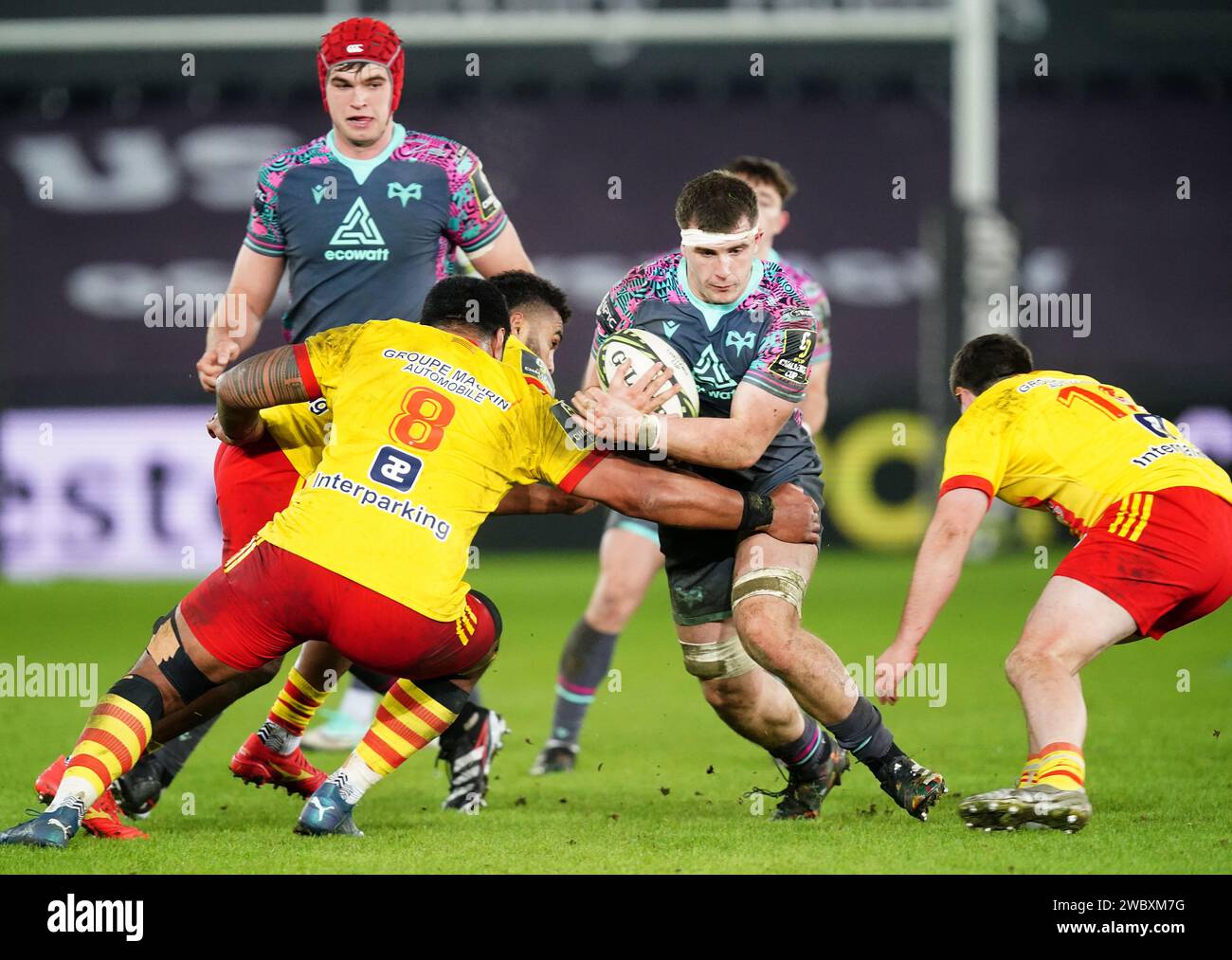 Ospreys' Morgan Morse (centre) is tackled by USA Perpignan's Sootala ...