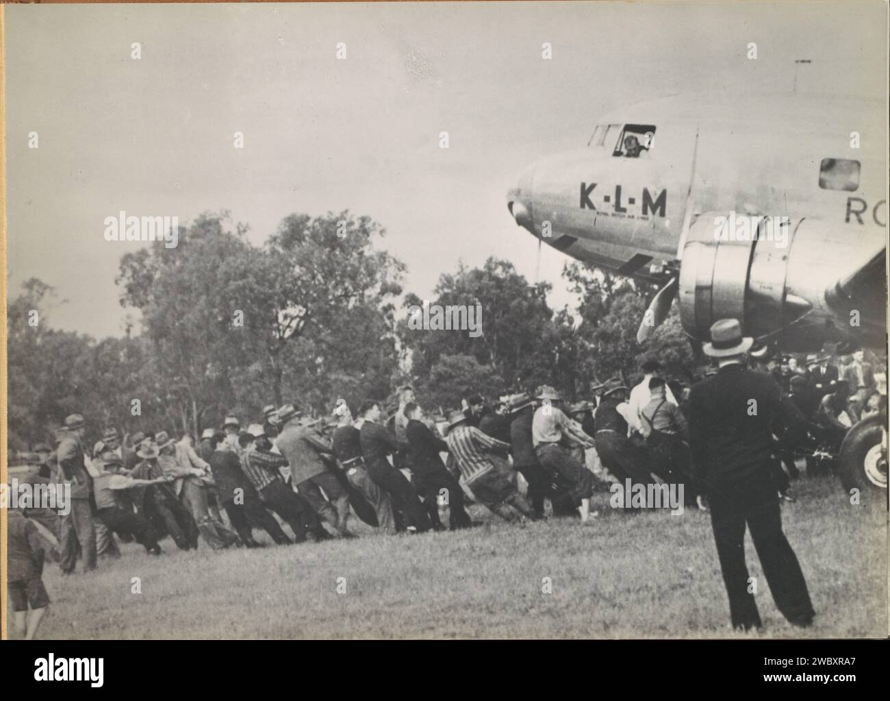 Men pull the 'Uiver' out of the mud, 1934 photograph Album magazine ...