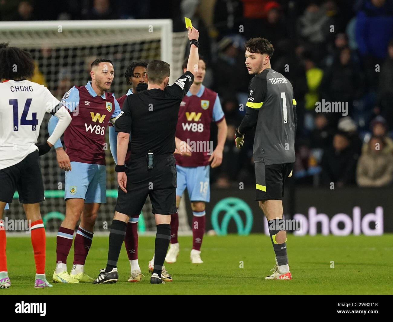 Burnley goalkeeper James Trafford is booked by referee Tony Harrington ...