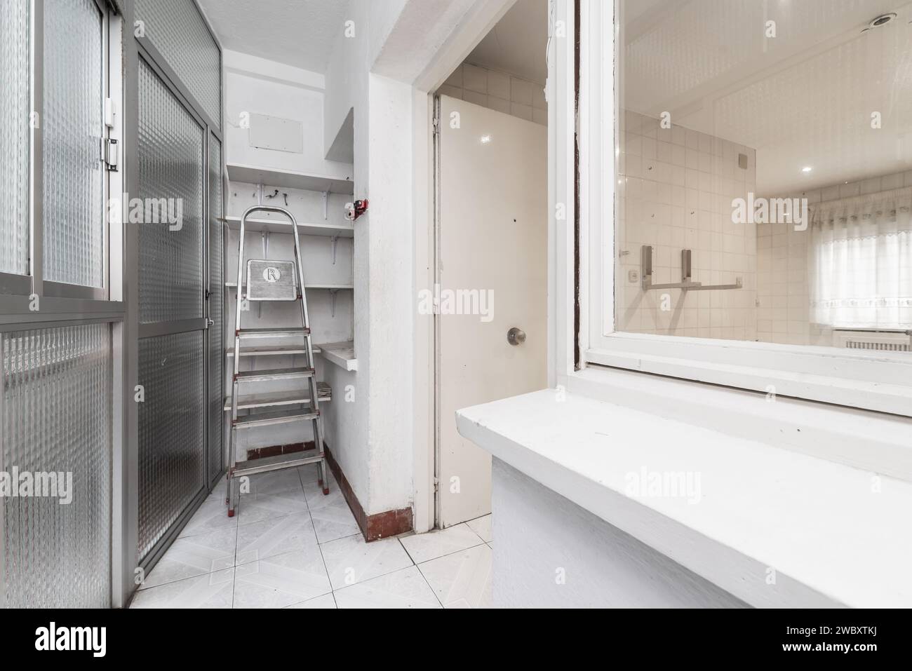 A small elongated terrace closed with aluminum and opaque glass and ...