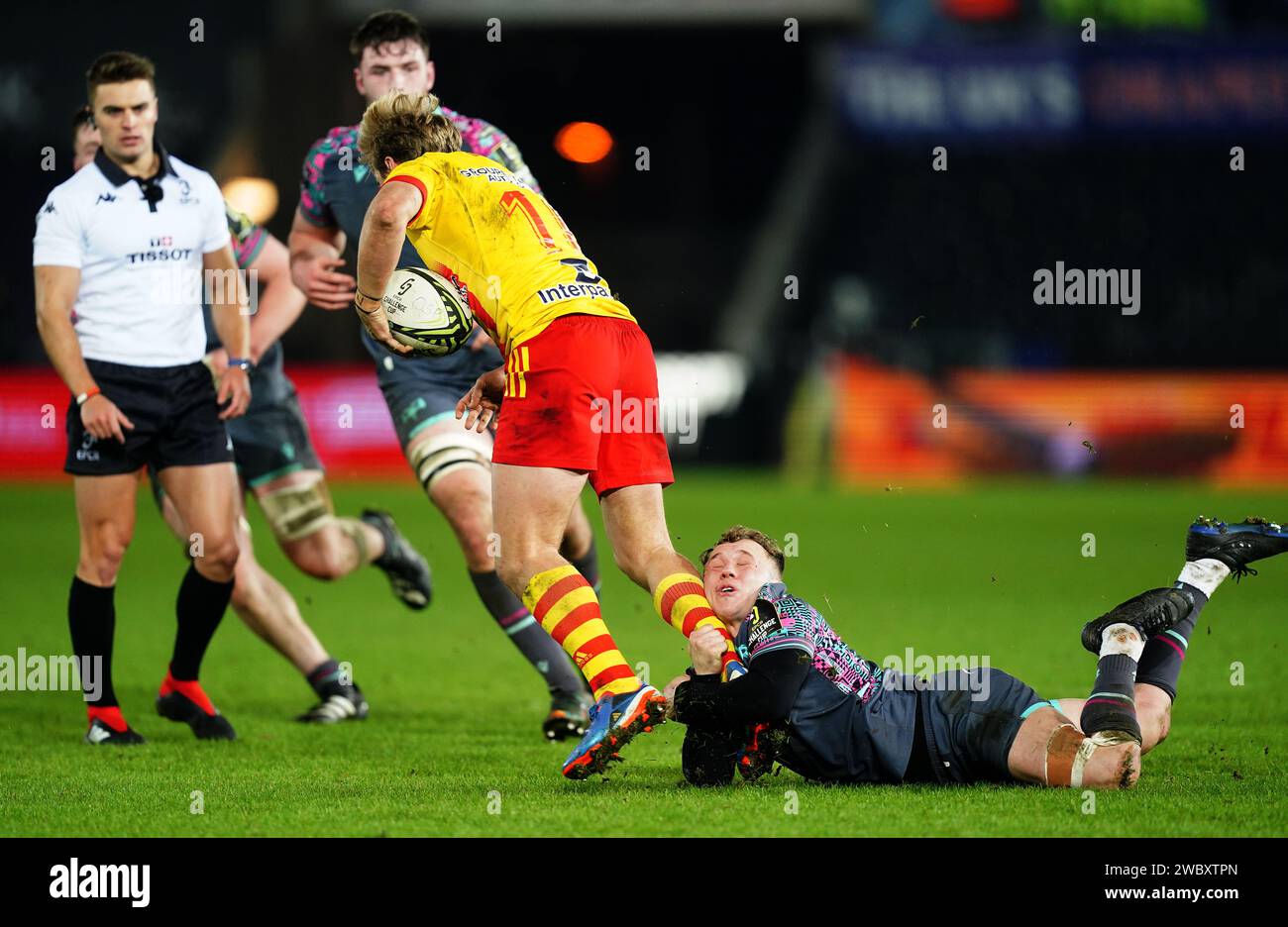 Ospreys' Luke Davies (right) tackles USA Perpignan's Jake McIntyre ...