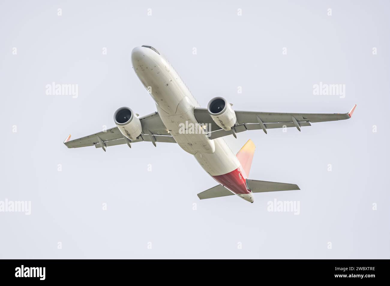 Fuselage of a passenger plane in flight just elevated from an airport ...