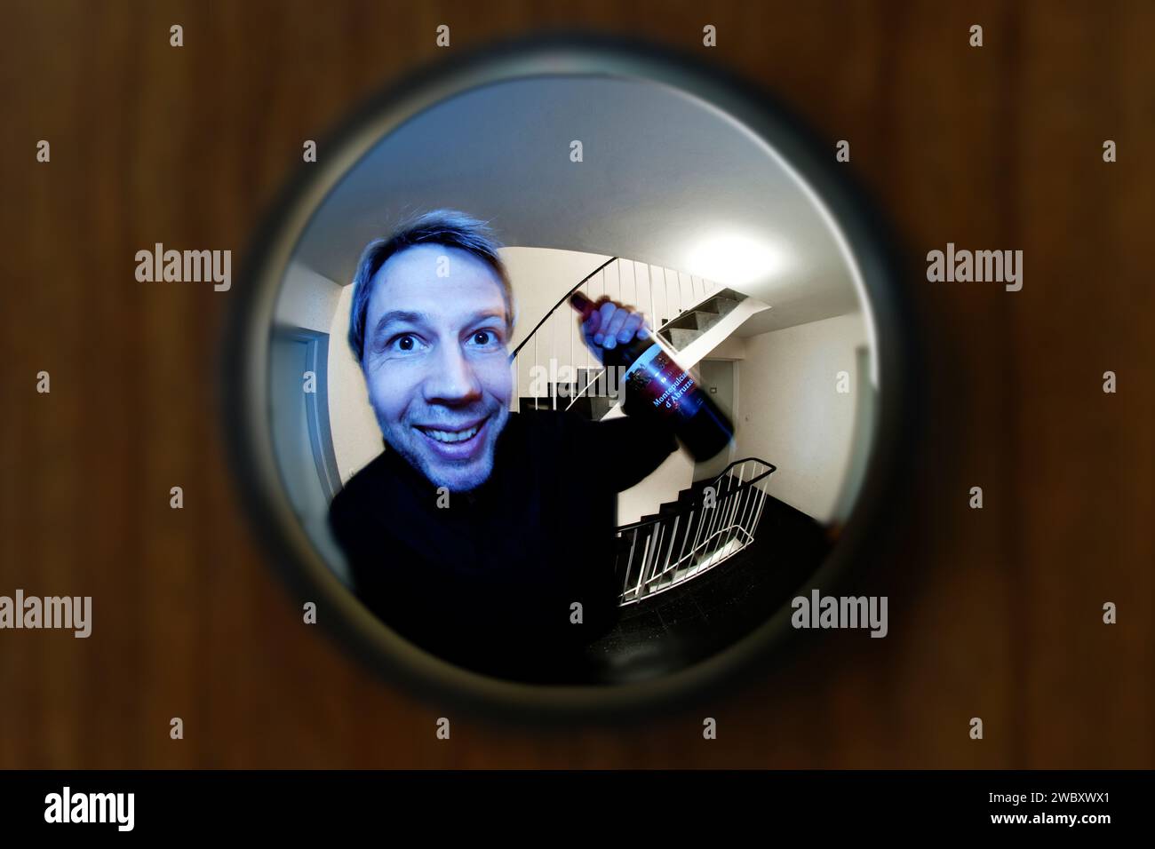 view through door viewer into a staircase of a big tenement, peephole ...