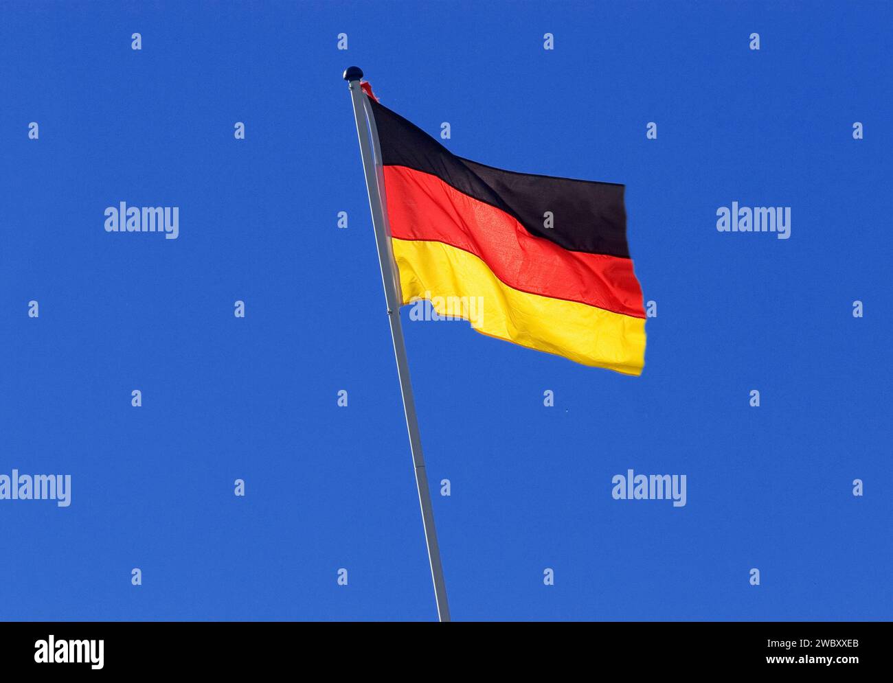 german national flag on a pole, blue sky as background, Germany Stock ...