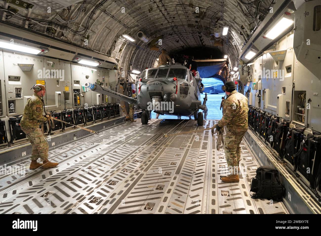 Airmen from the 176th and 718th Aircraft Maintenance Squadrons off-load ...