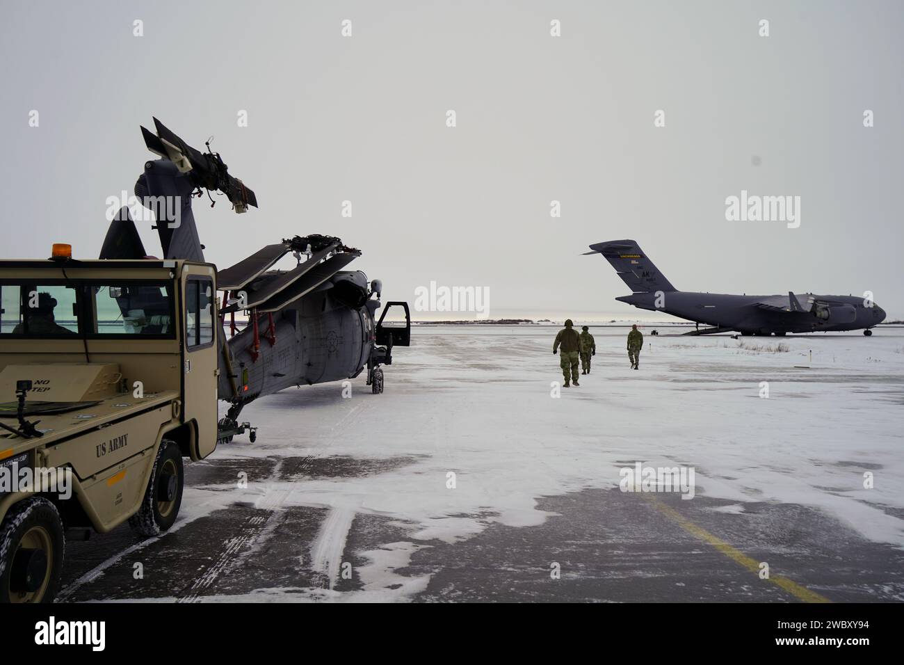 Airmen from the 176th and 718th Aircraft Maintenance Squadrons tow an ...
