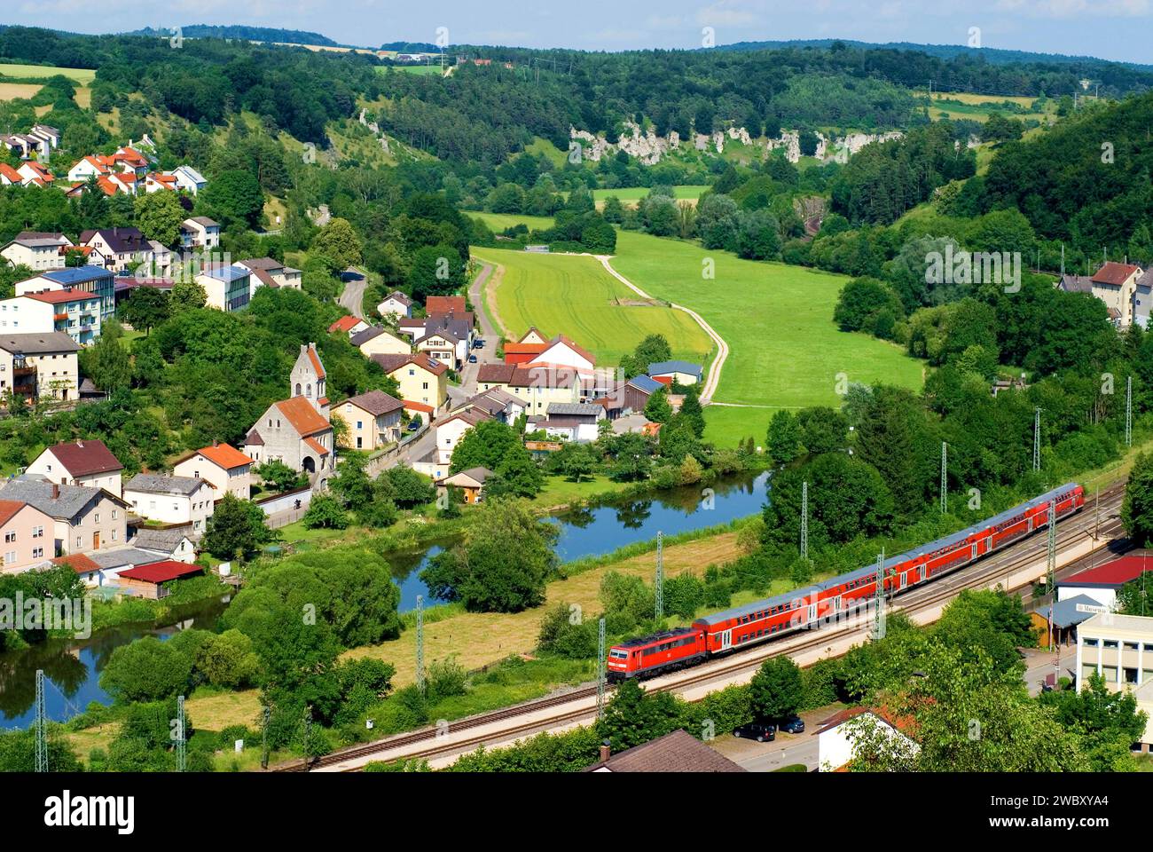 Altmühltal, village of Solnhofen, red train, green meadows, landscape ...