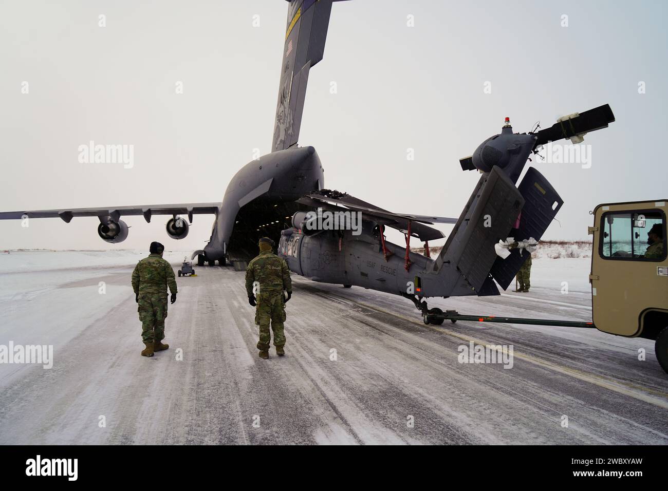 Airmen from the 176th and 718th Aircraft Maintenance Squadrons tow an ...
