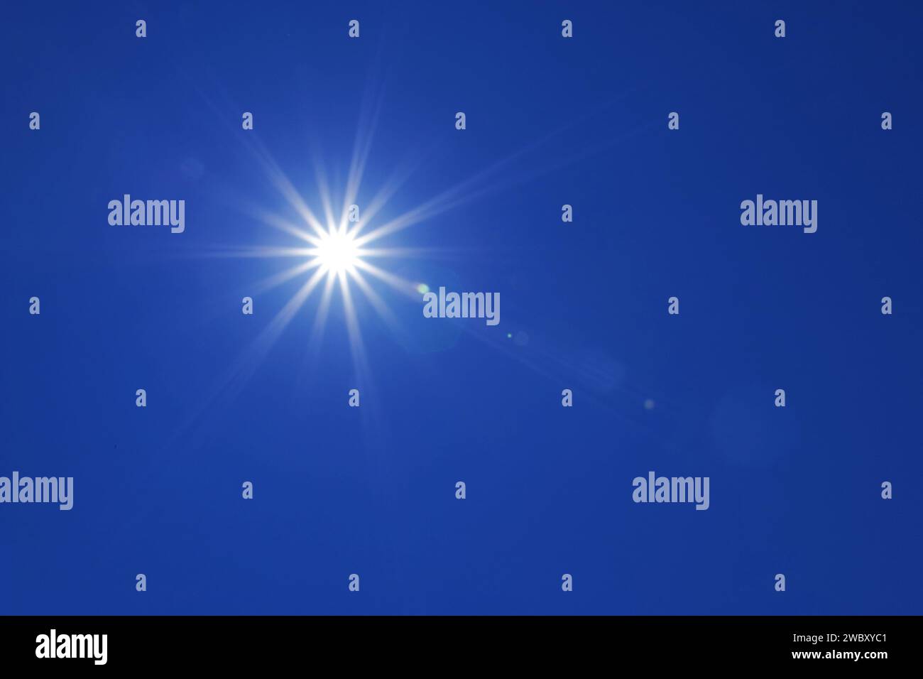 sun in blue sky Stock Photo - Alamy