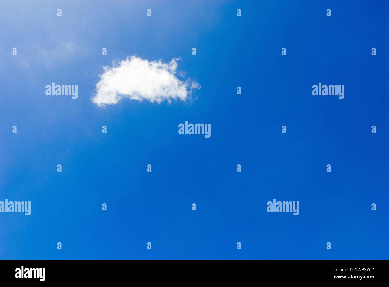 one single small fluffy white fair weather cloud (cumulus humilis) in ...