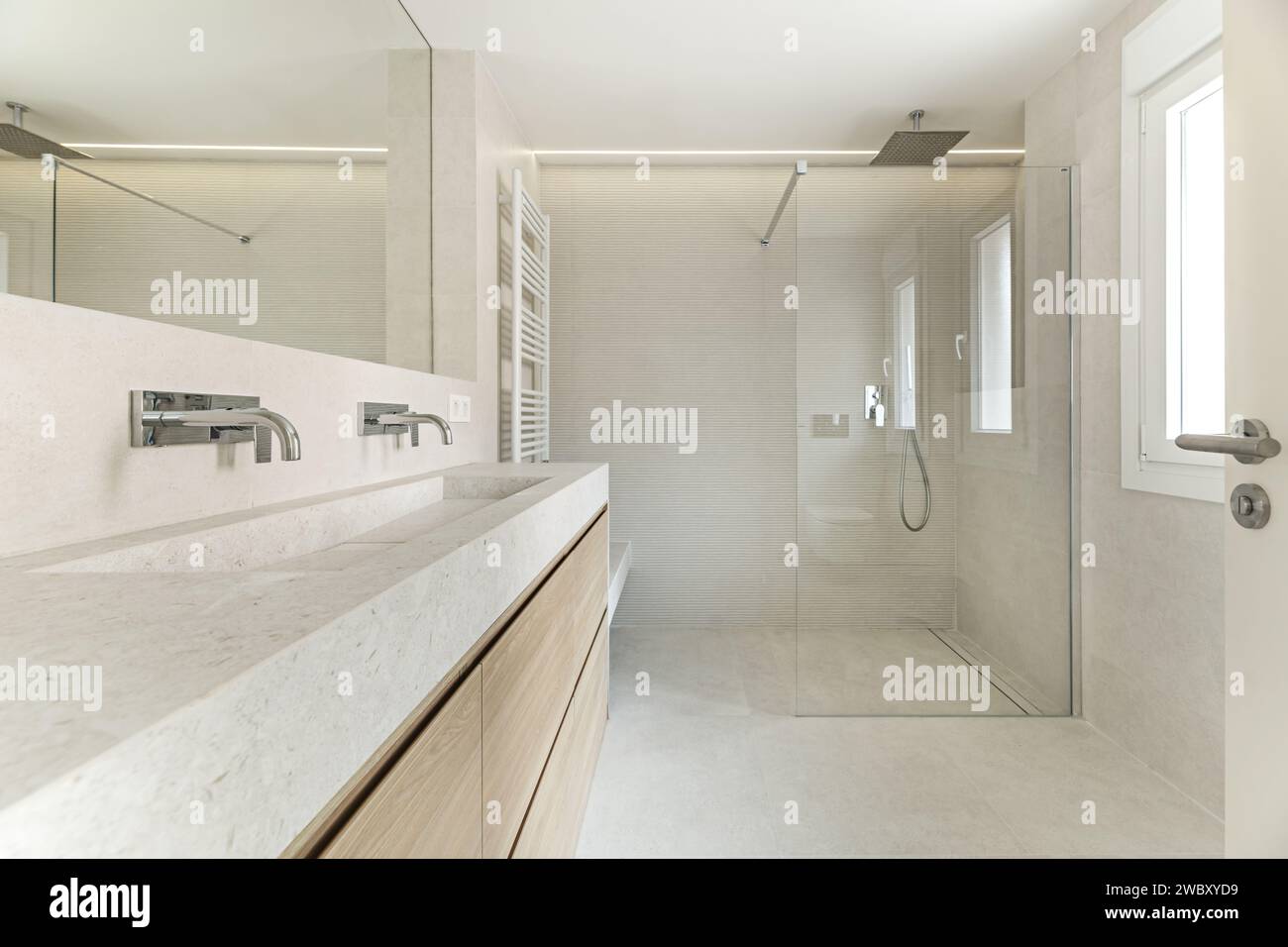 Modern design bathroom with a mirror integrated into the wall, cream ...