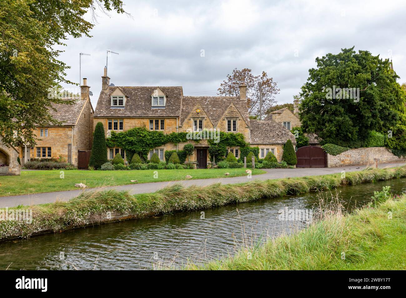 Lower Slaughter village Cotswolds England and rows of English honey ...