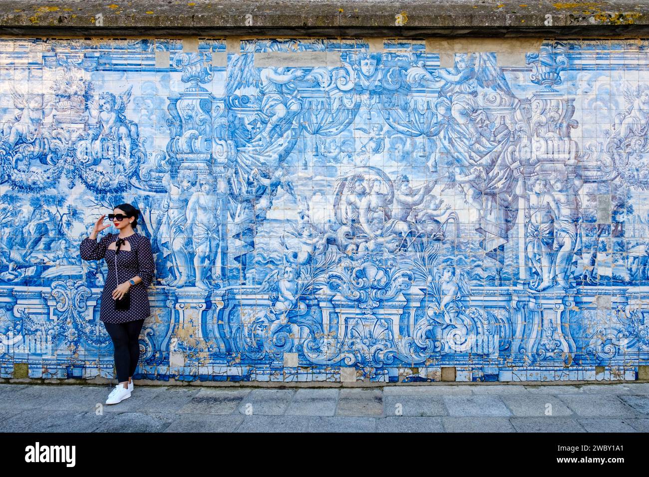 Woman tourist posing for a photo, Sé do Porto, Porto Cathedral, azulejo ...