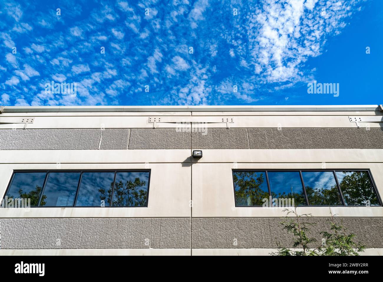 Soft clouds hovering above the facade of a modern office building Stock ...