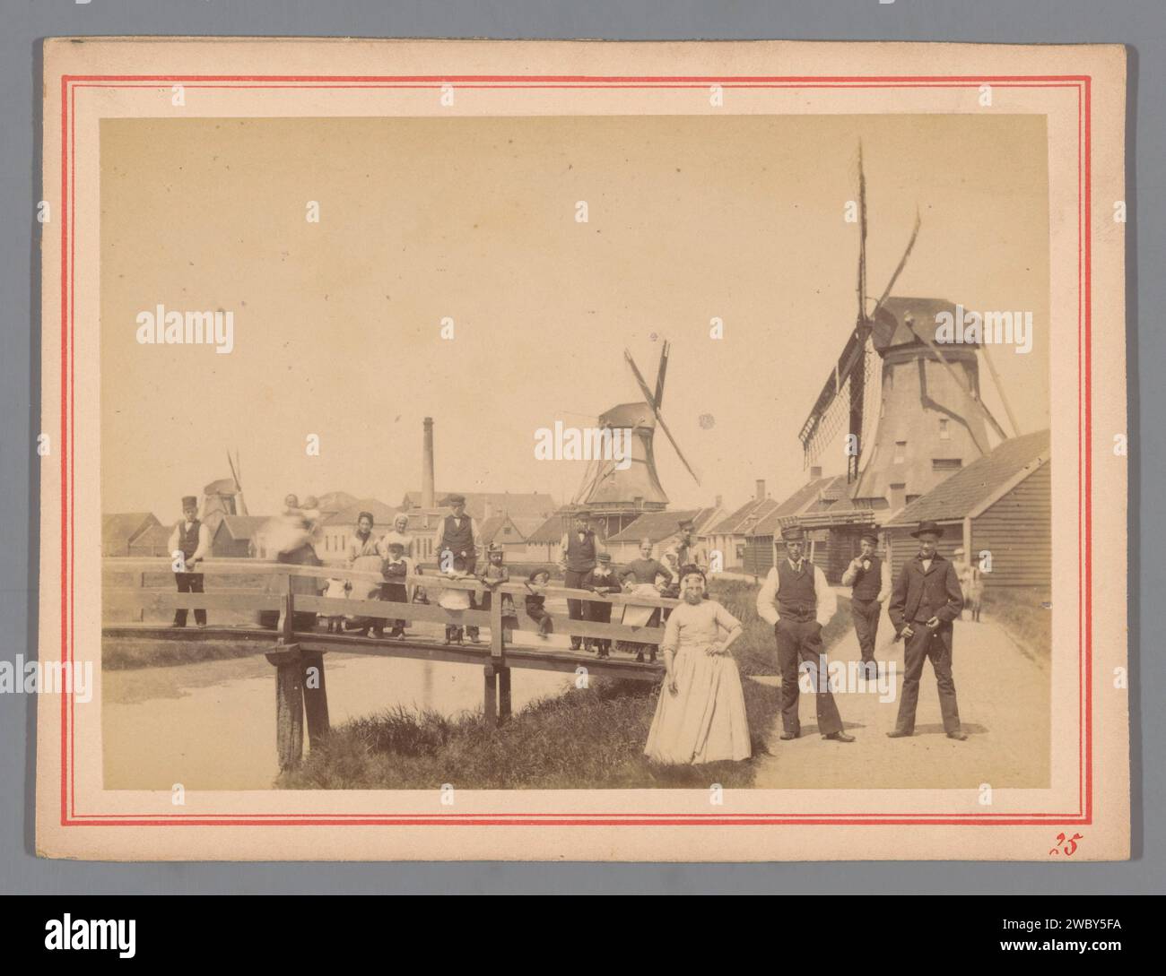 Group portrait in traditional costume on a bridge at the windmills of ...
