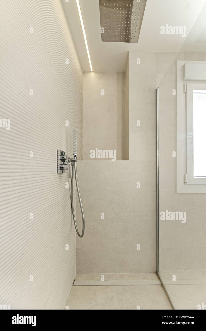 Interior of a shower cabin with a niche, chrome steel faucets, cream ...
