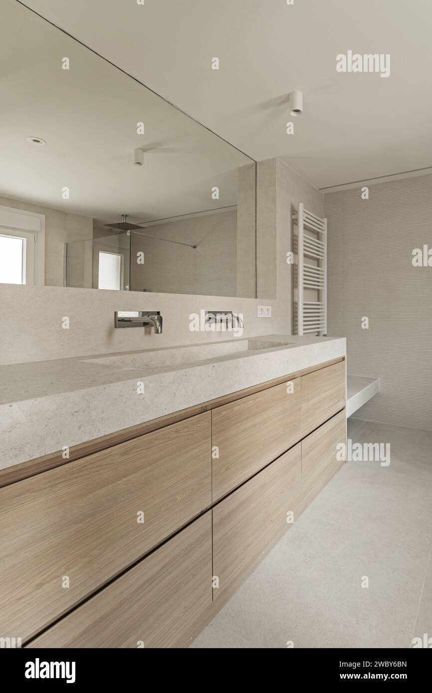 Modern design bathroom with cream marble sink on wooden cabinet with ...