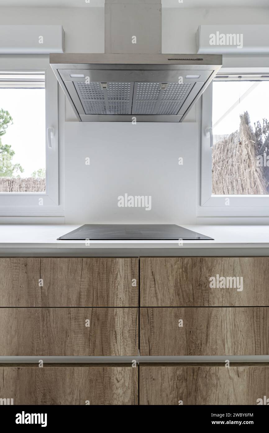 Kitchen with black ceramic hob, stainless steel extractor hood, two ...