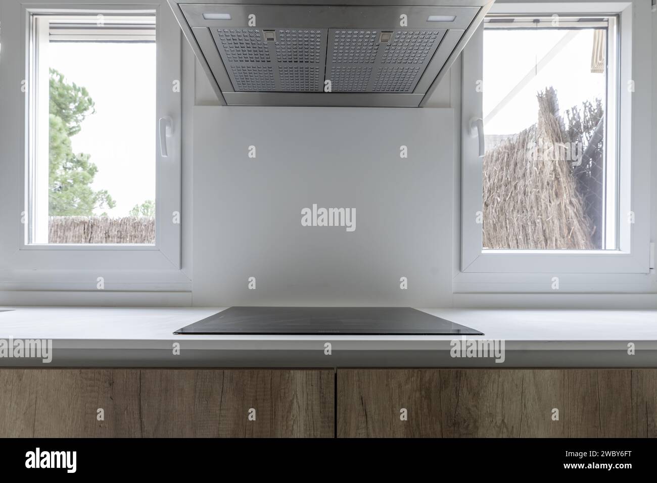 Kitchen with black ceramic hob on the wall without backsplash ...