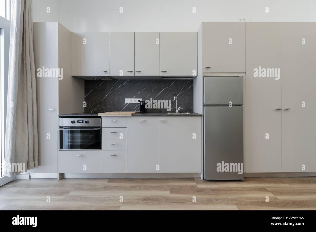 Frontal image of an open plan kitchen in a loft apartment with light ...